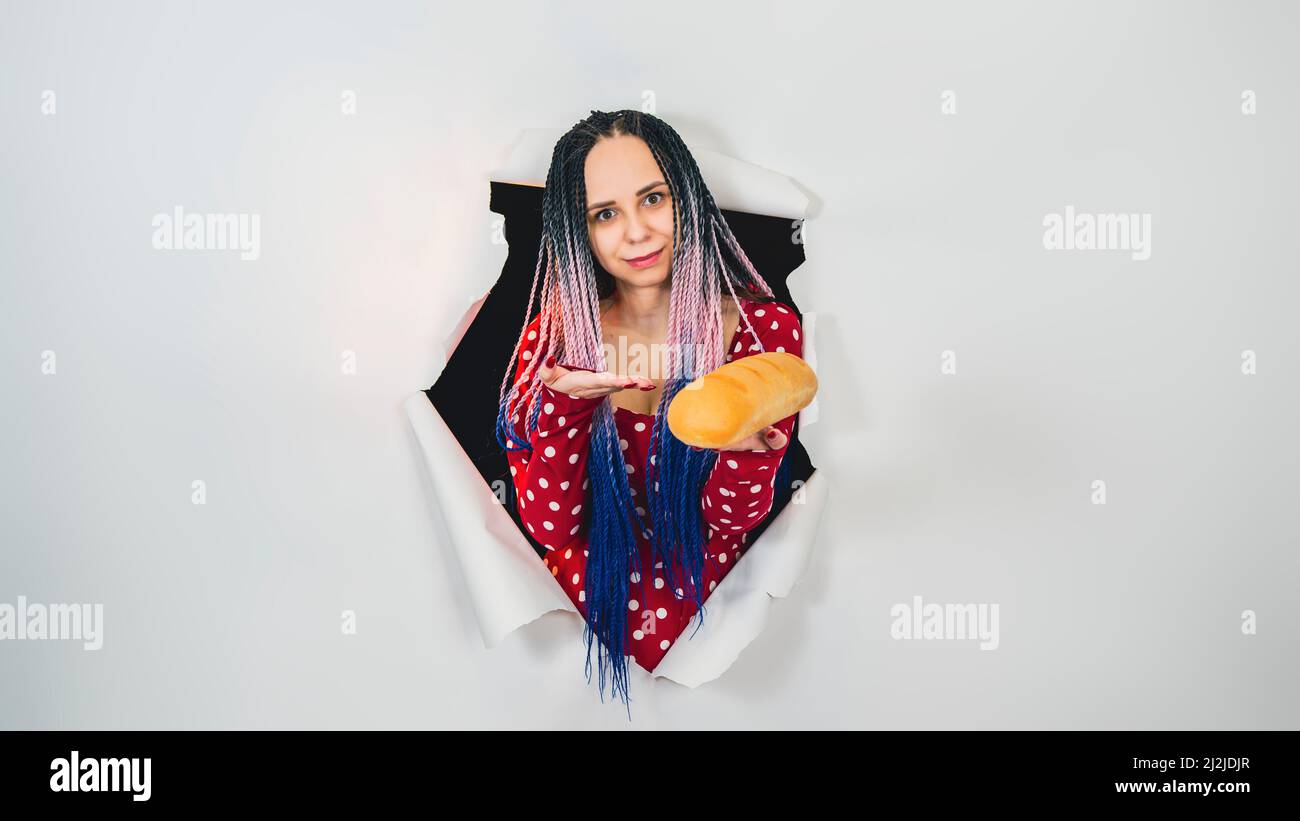 Female in a red dress with loaf in hole of white background Stock Photo ...