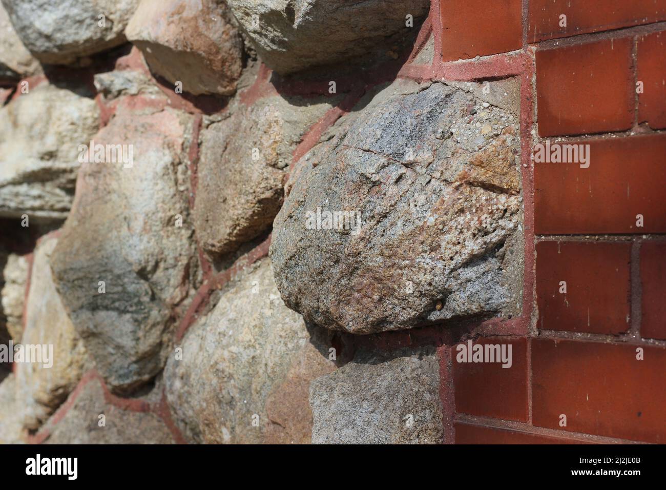 Rustic stone wall built with round boulders and granite stones Stock ...