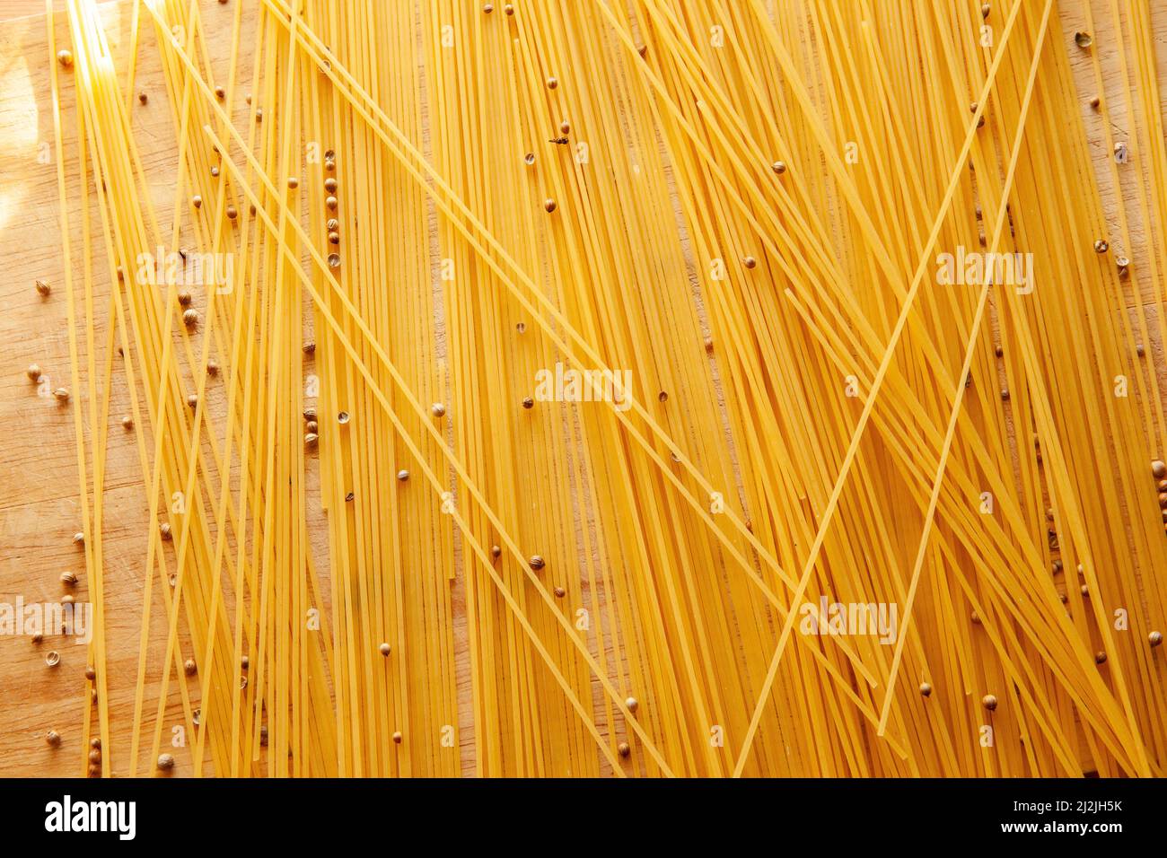 Spaghetti scattered on the table with black pepper peas. Italian food ...