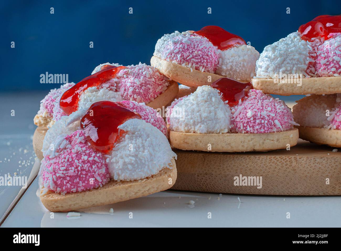 marshmallow cookies with dry coconut flakes and strawberry jam on a ...