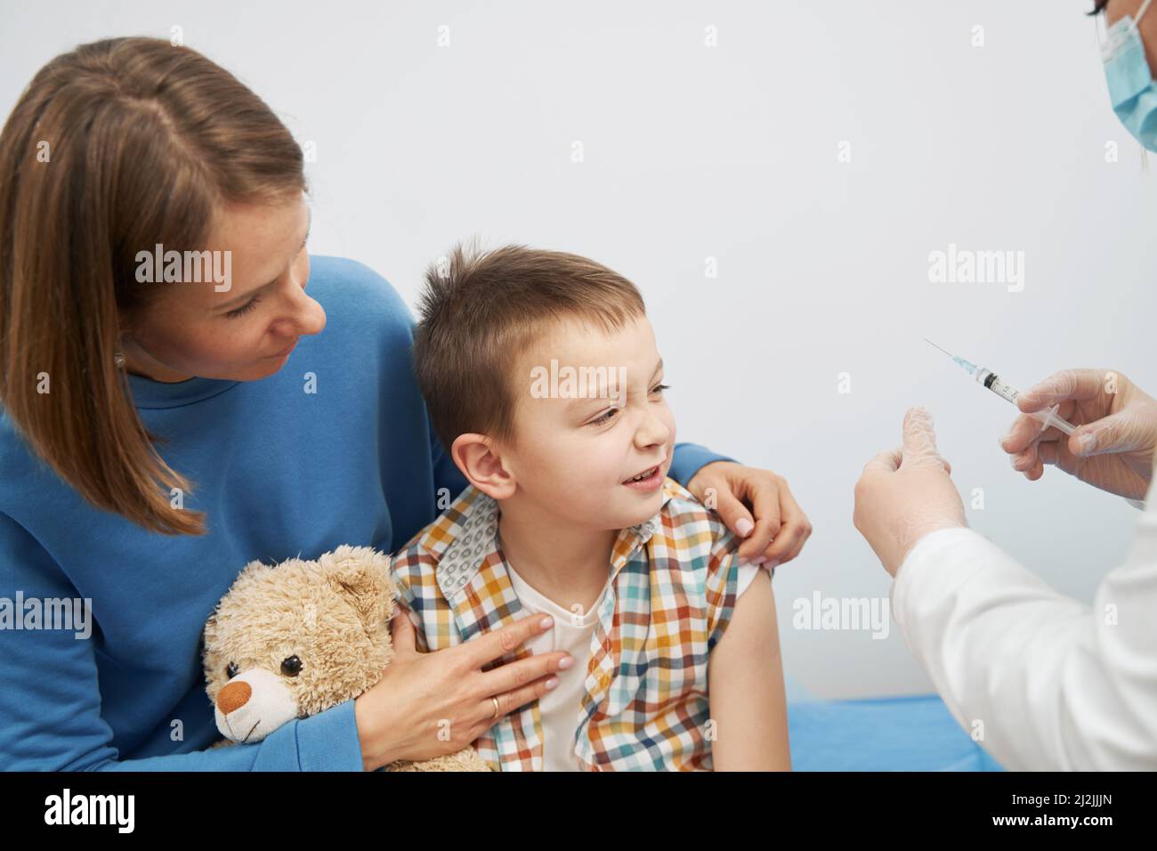 Little boy receiving vaccine injection in pediatric clinic Stock Photo ...