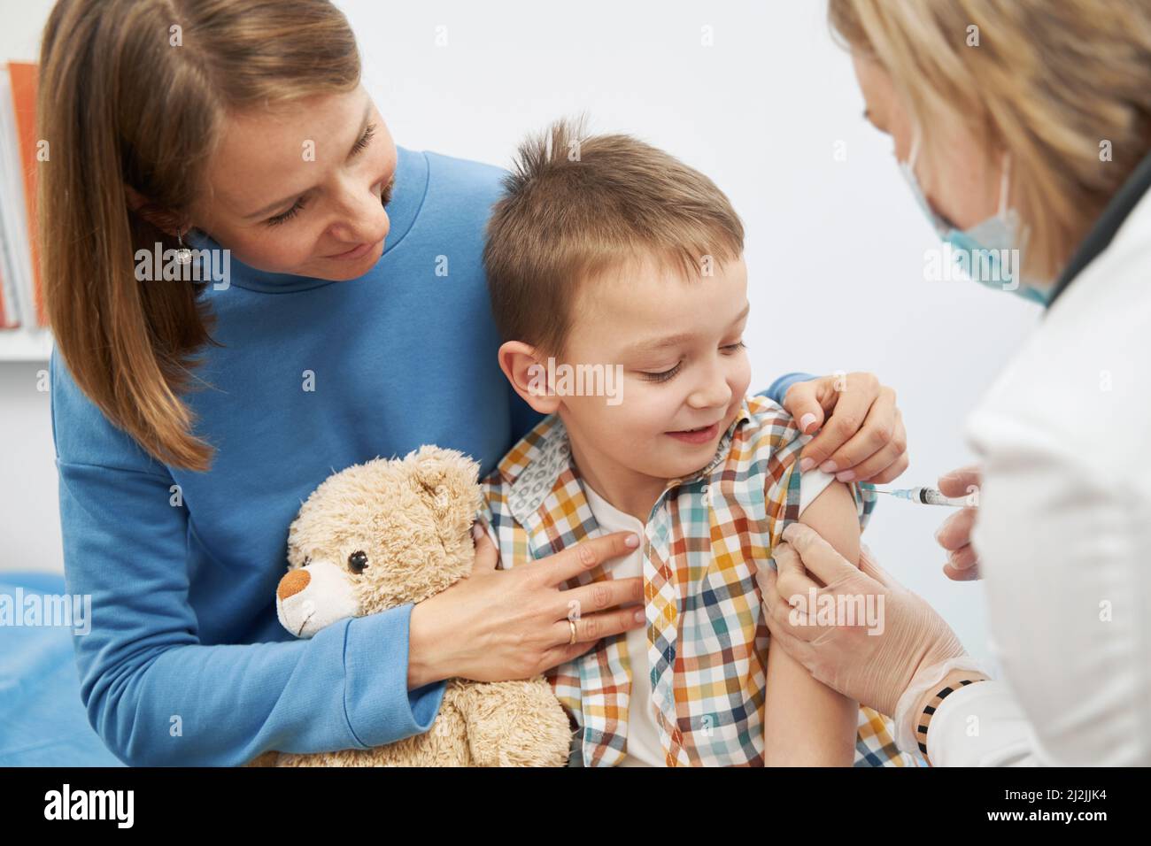 Smiling child receiving vaccine injection in pediatric clinic Stock ...