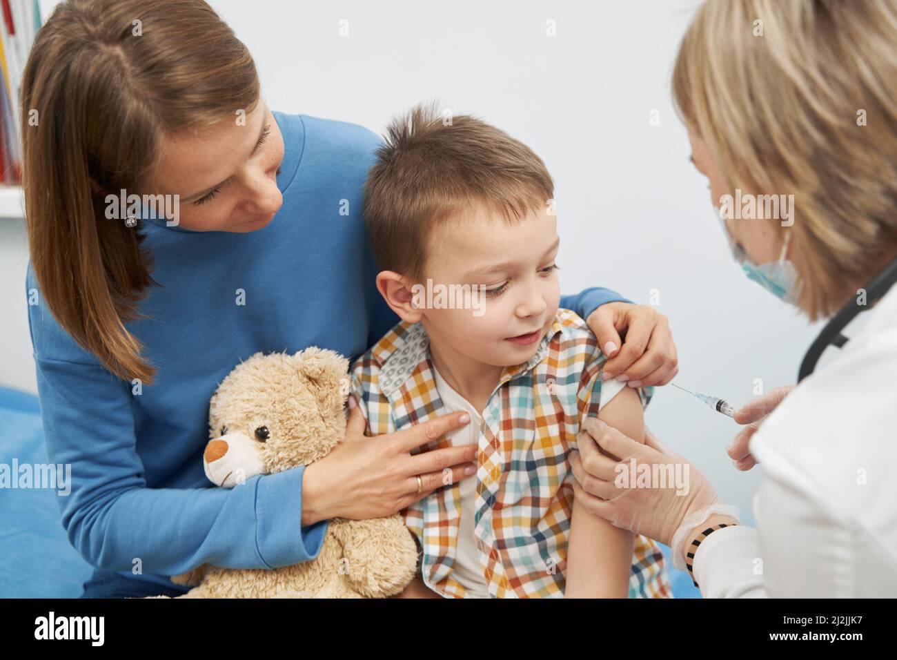 Little boy getting vaccine injection in pediatric clinic Stock Photo ...