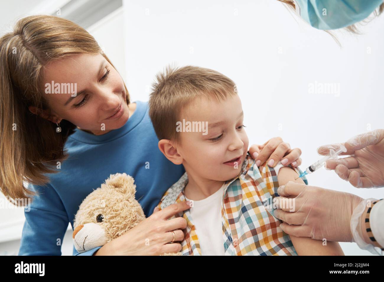 Little boy receiving vaccine injection in pediatric clinic Stock Photo ...