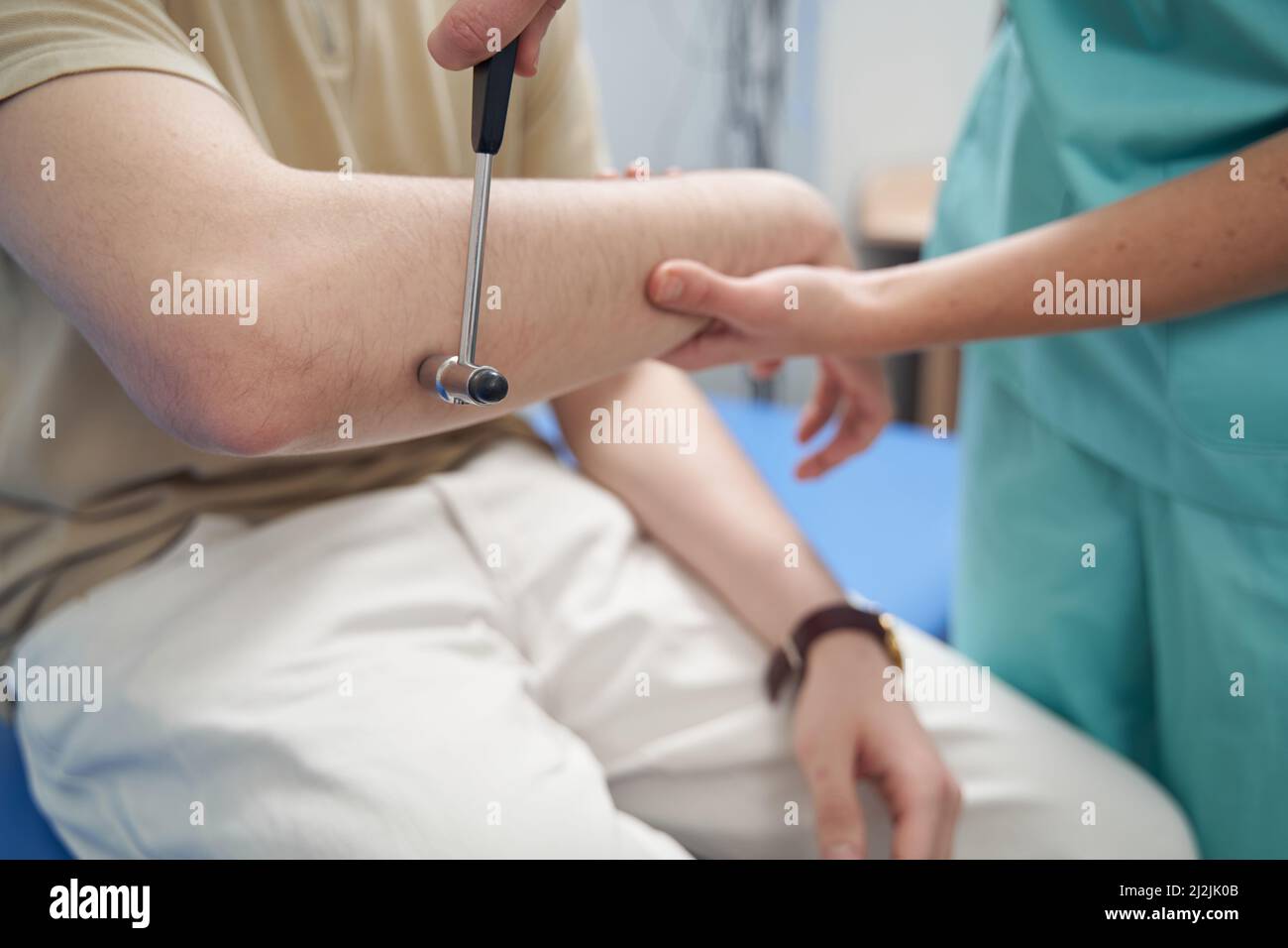 Female neurologist doing check up of male patient Stock Photo - Alamy