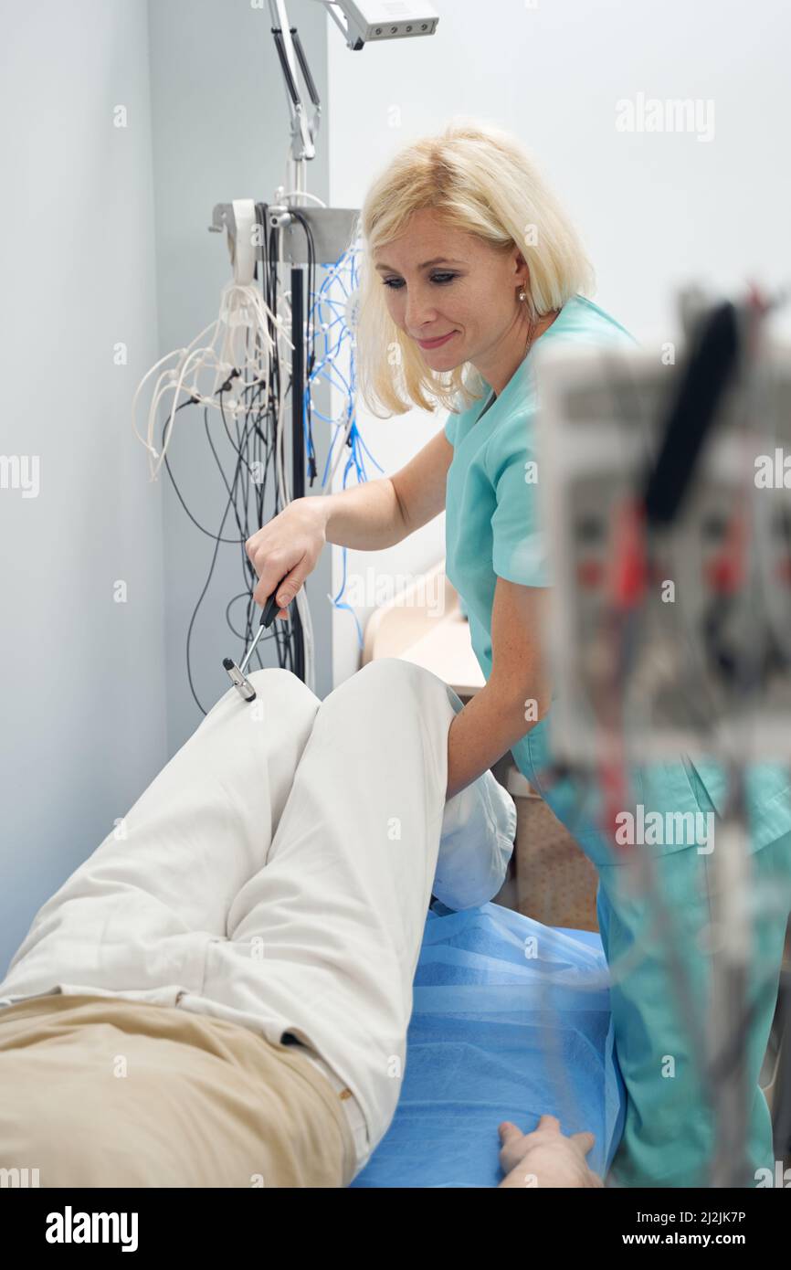 Cheerful neurologist treating male patient on couch Stock Photo - Alamy