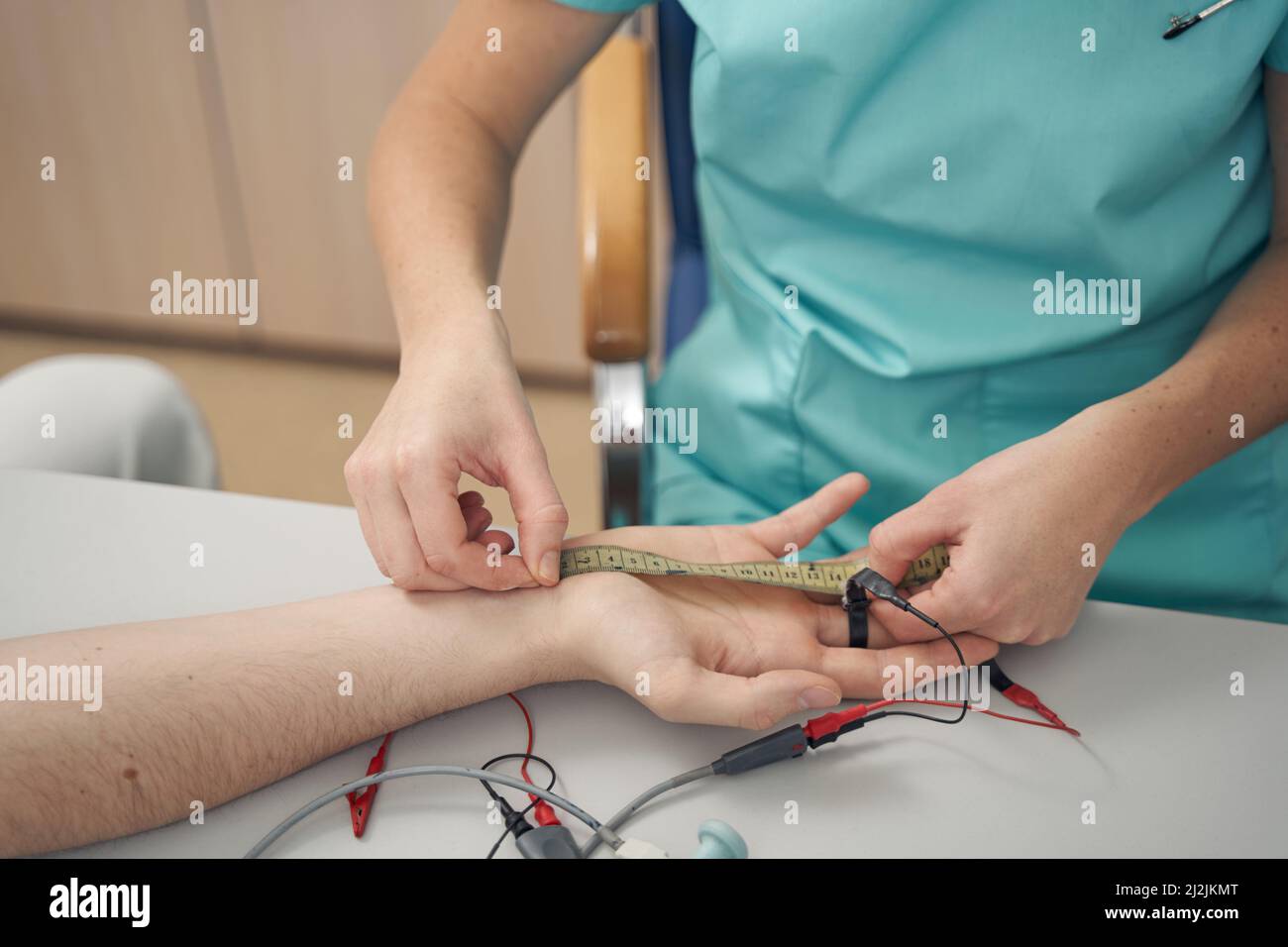 Female doctor examining male hand in clinic Stock Photo - Alamy