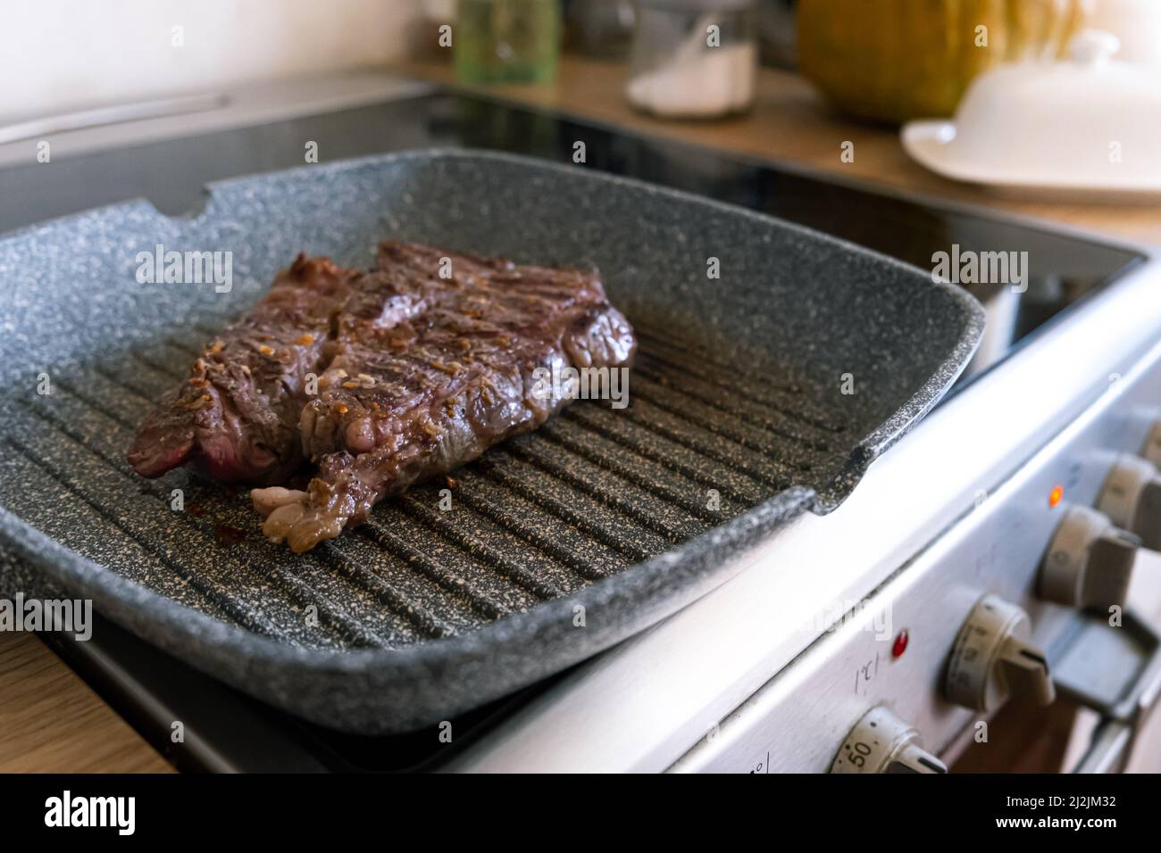 Juicy beef meat steak cooking on griddle pan at professional kitchen ...