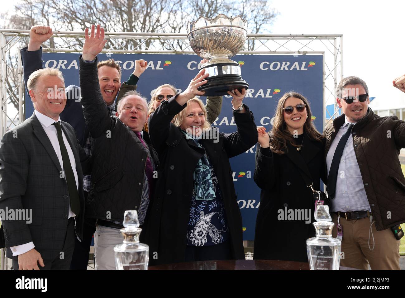 Sue Howell, owner of Win My Wings, lifts the trophy for the Coral ...
