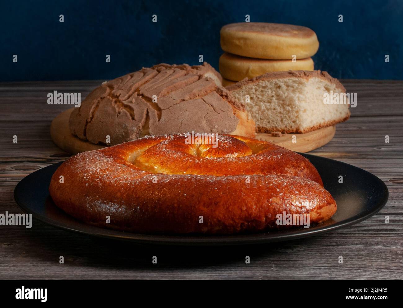 Concept of Mexican sweet bread made in Oaxaca on a rustic wooden table ...