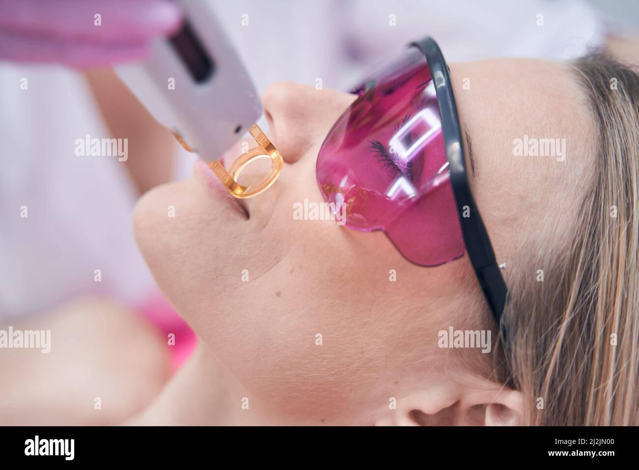 Young female patient undergoing non-invasive medical procedure Stock ...
