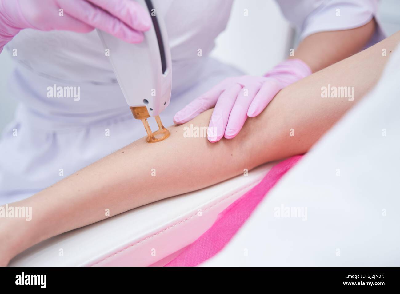 Experienced dermatologist carrying out laser epilation procedure Stock ...