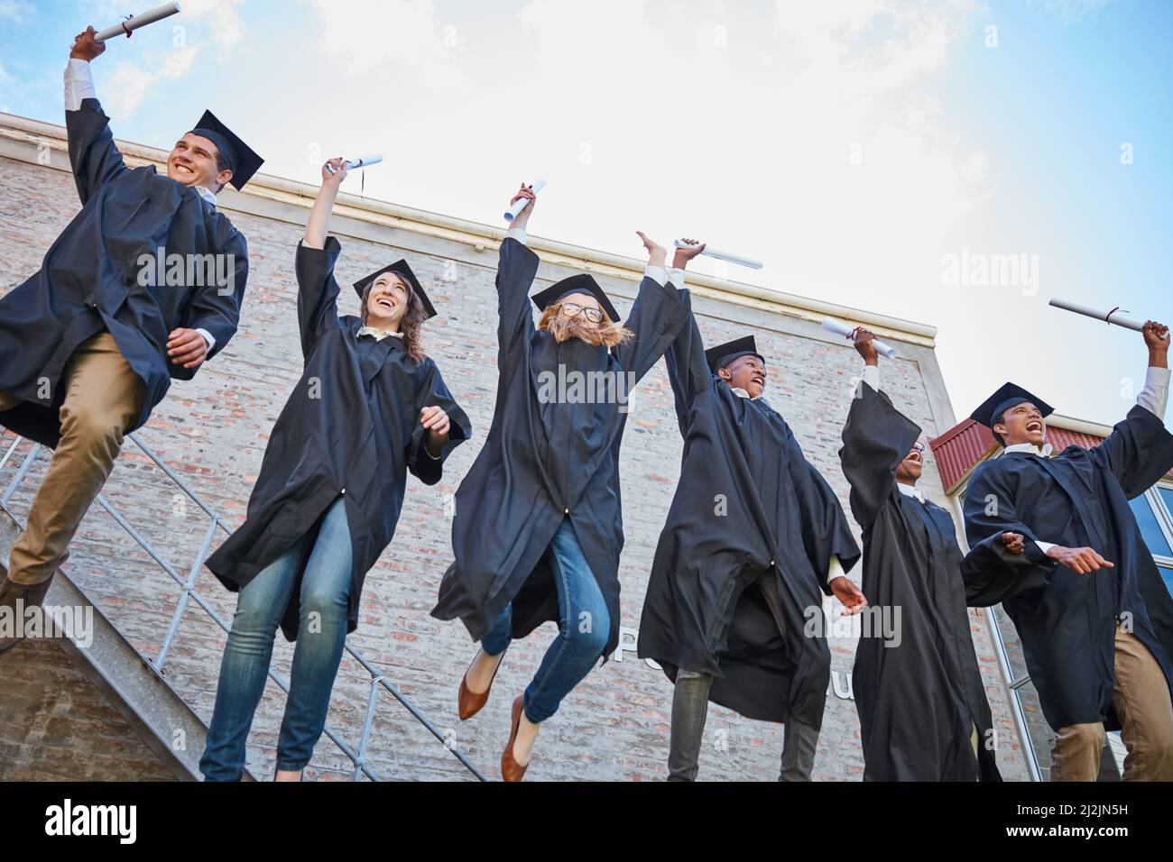 Graduation is a cause for celebration. Low angle shot of a happy group ...