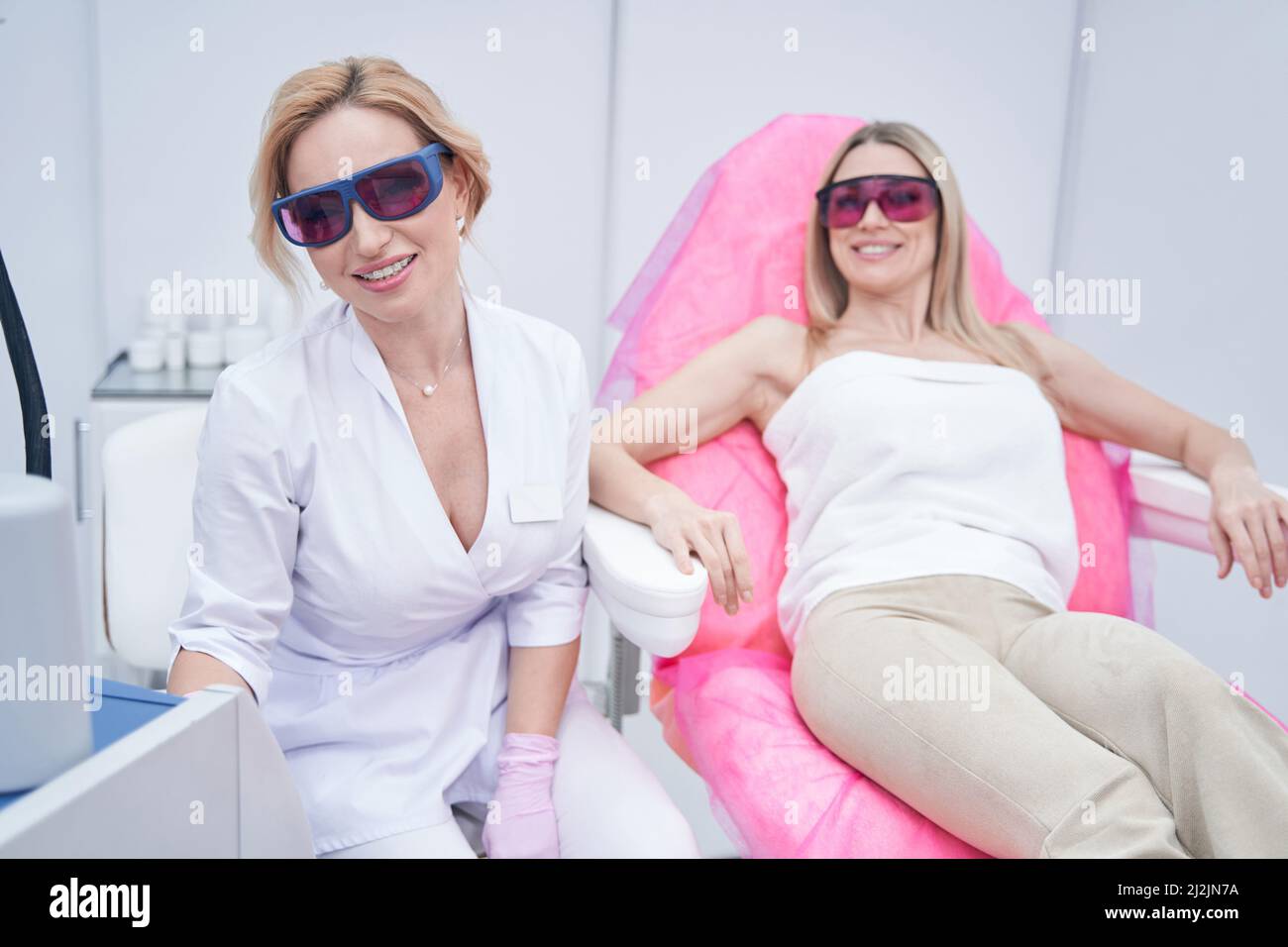 Doctor and patient in safety goggles before laser therapy session Stock ...