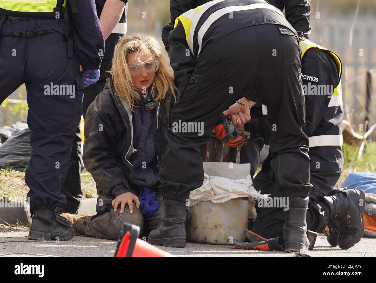 Police officers from the Protester Removal Team work to free a Just ...