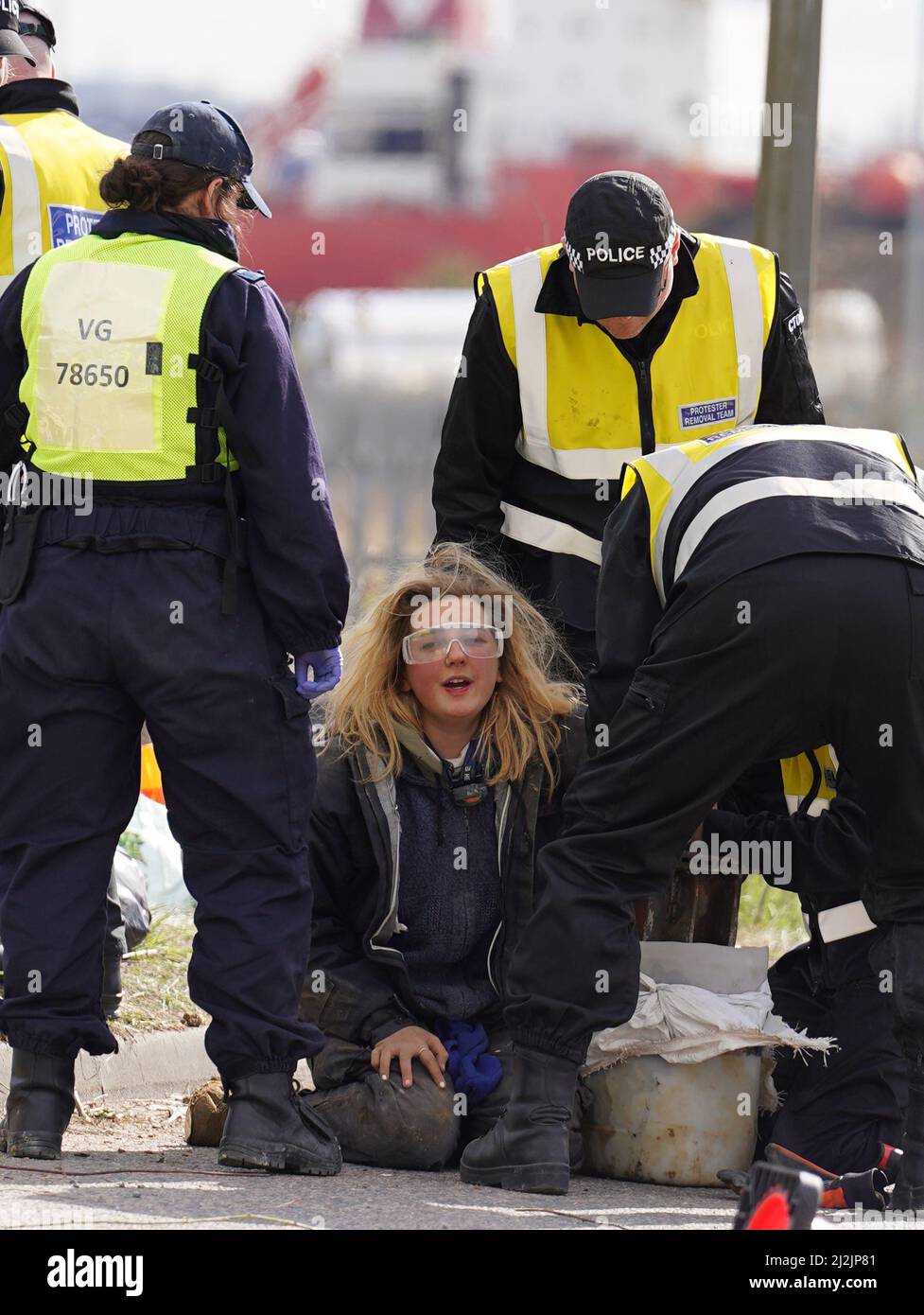Police officers from the Protester Removal Team work to free a Just ...