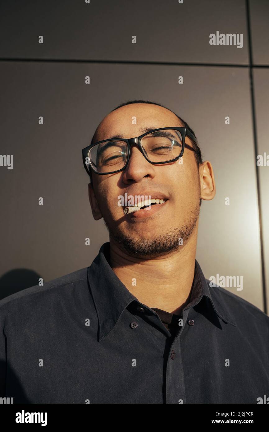Man smoking a white paper joint close up Stock Photo - Alamy