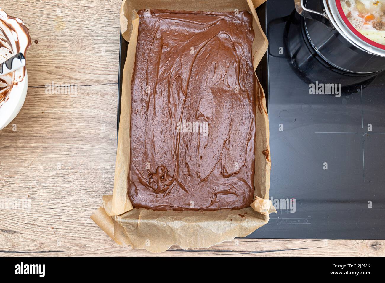 Baking tray filled entirely with thick cocoa mass, ready for baking ...