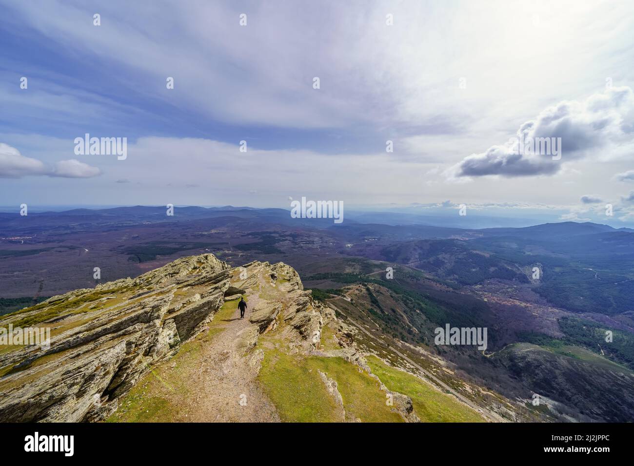 High mountain summit with man hiking at the top of the hill Stock Photo ...