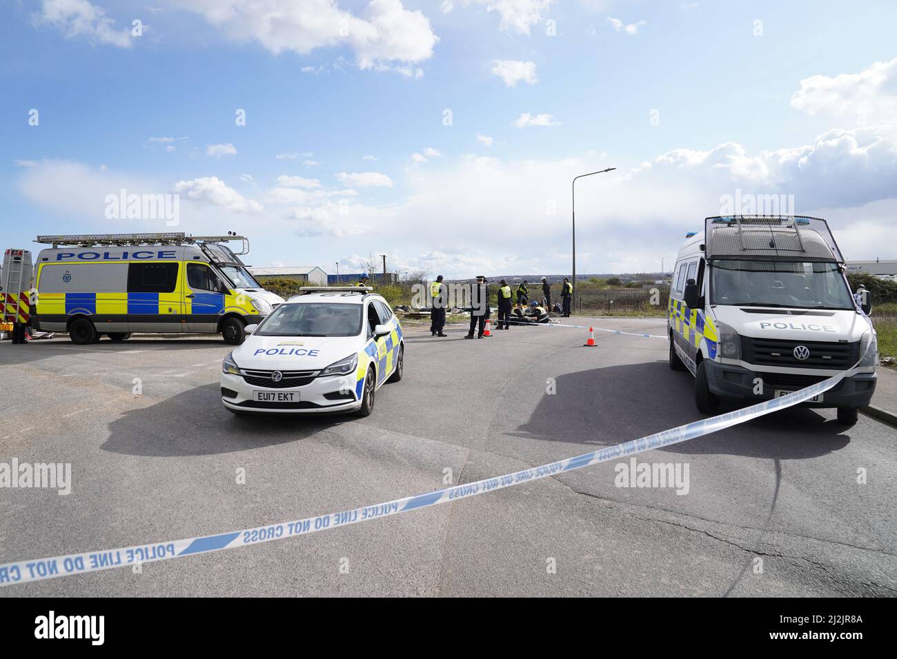 Police officers from the Protester Removal Team work to free a Just ...