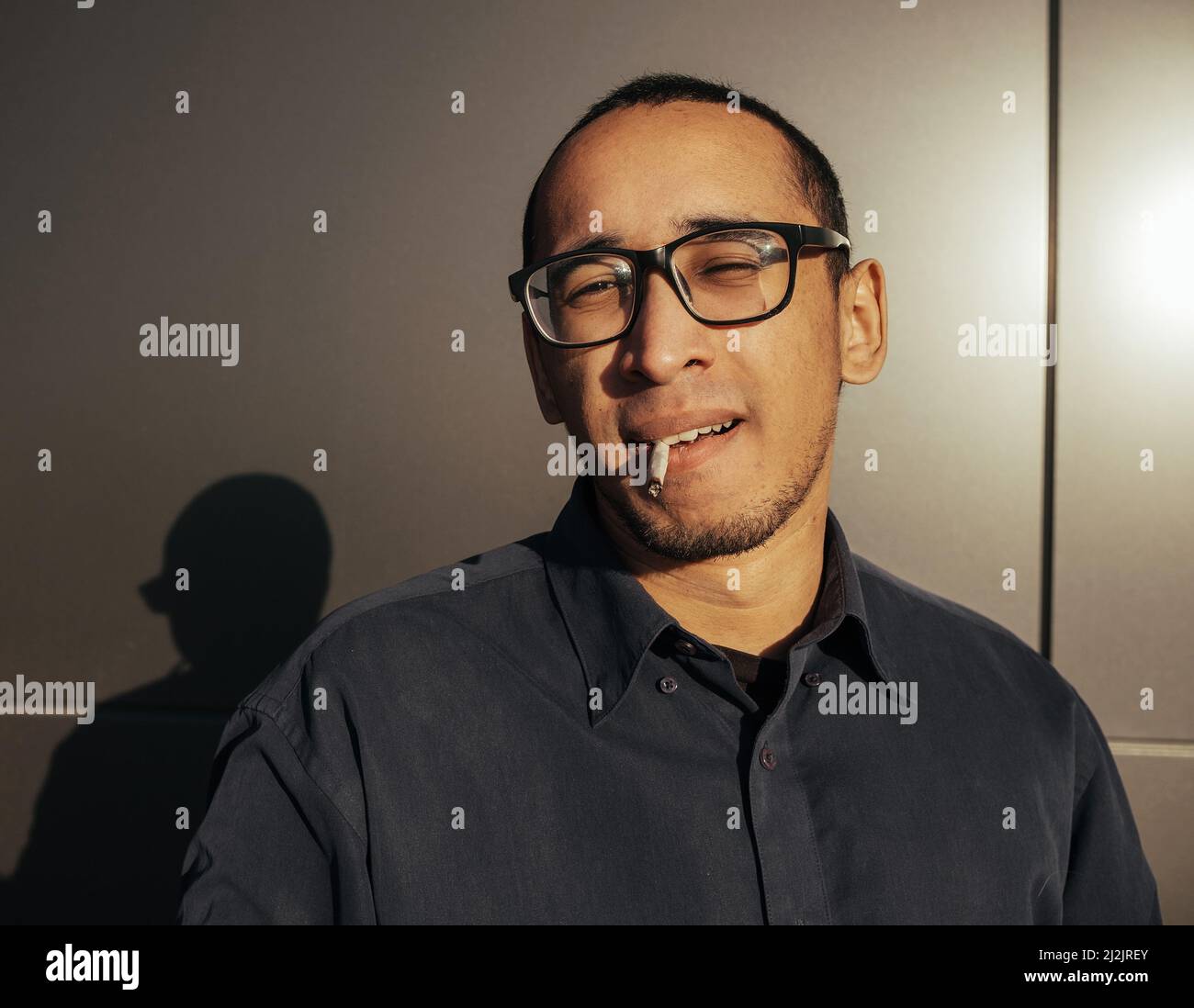 Man smoking a white paper joint close up Stock Photo - Alamy