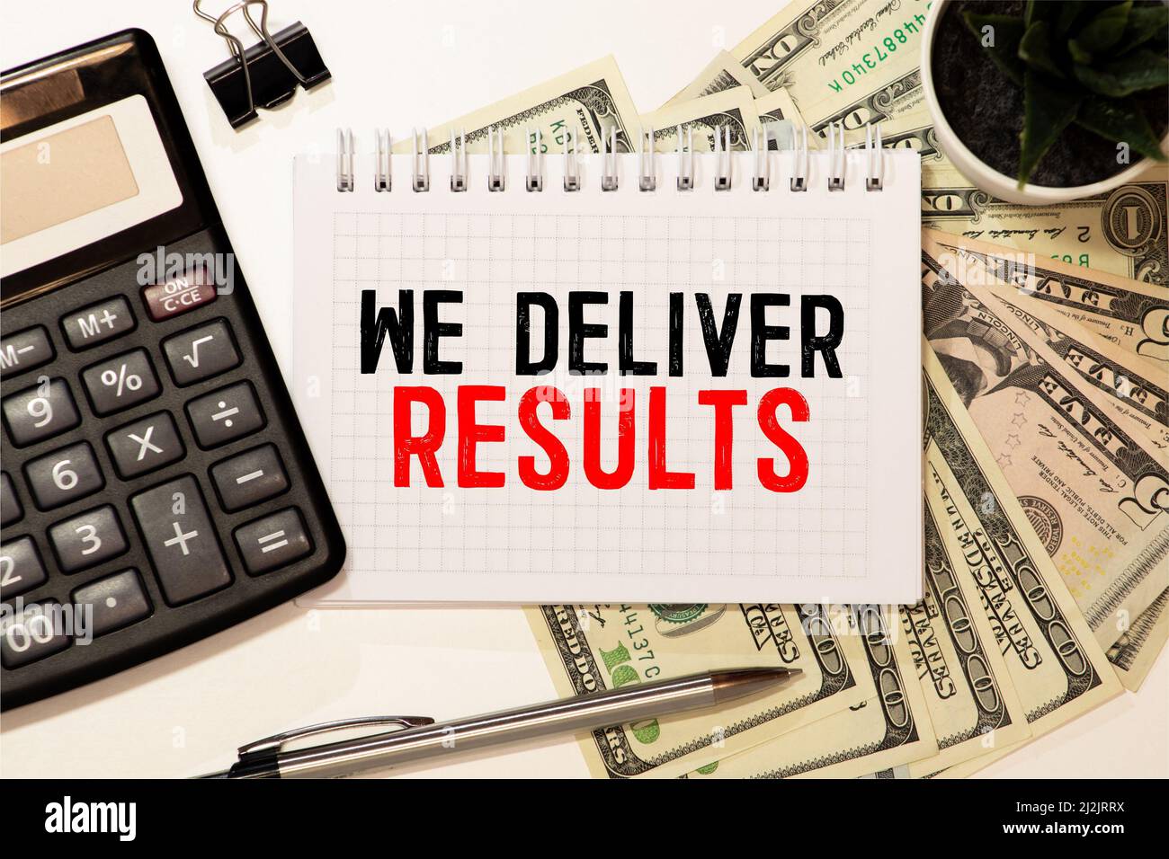 We Deliver Results text on paper, business concept Stock Photo - Alamy