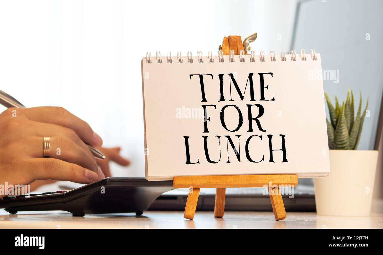 Chalkboard with the words lunch time written on it isolated against a ...