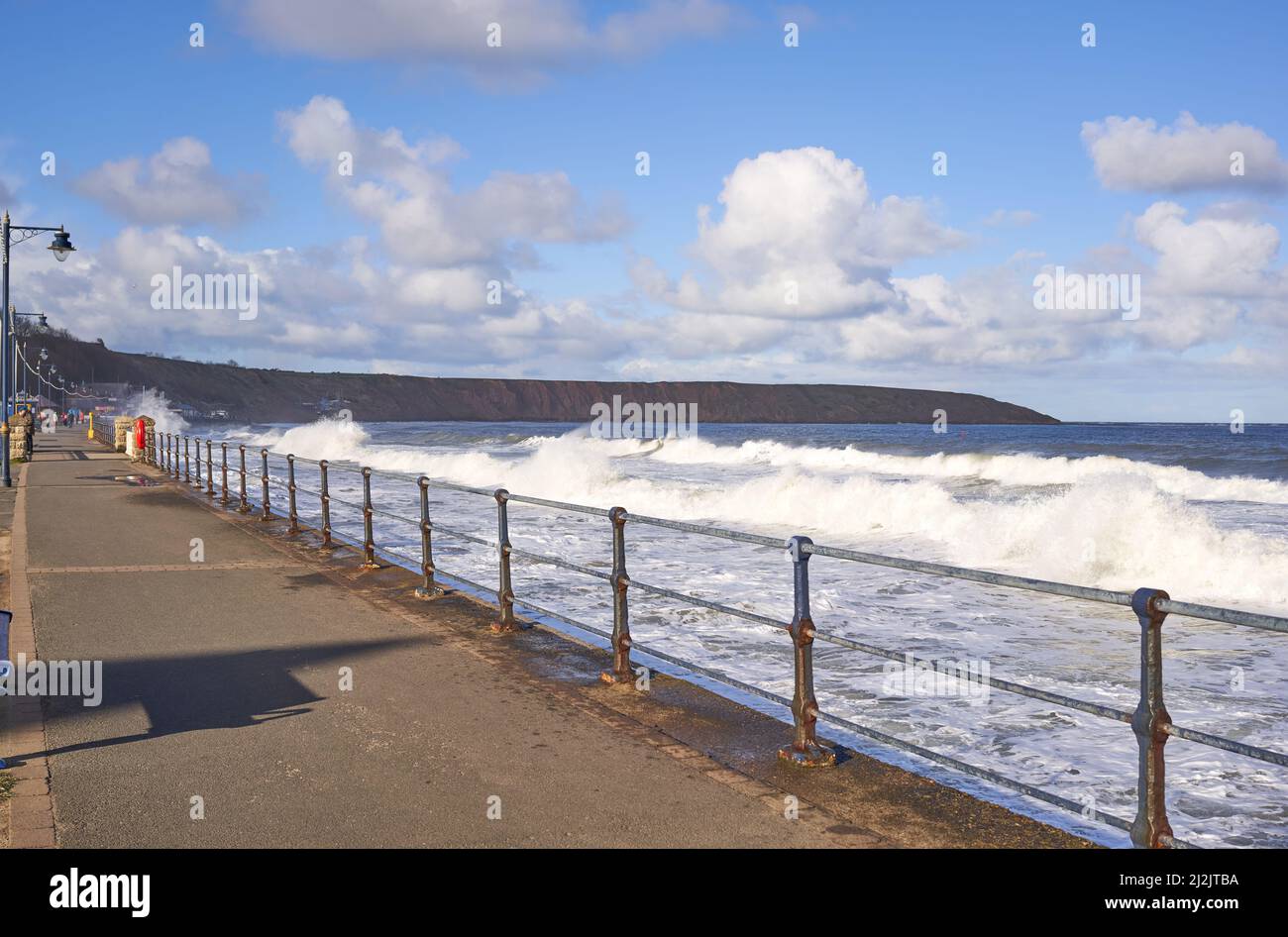 Waves crashing against a sea wall in Filey, Yorkshire, UK Stock Photo ...