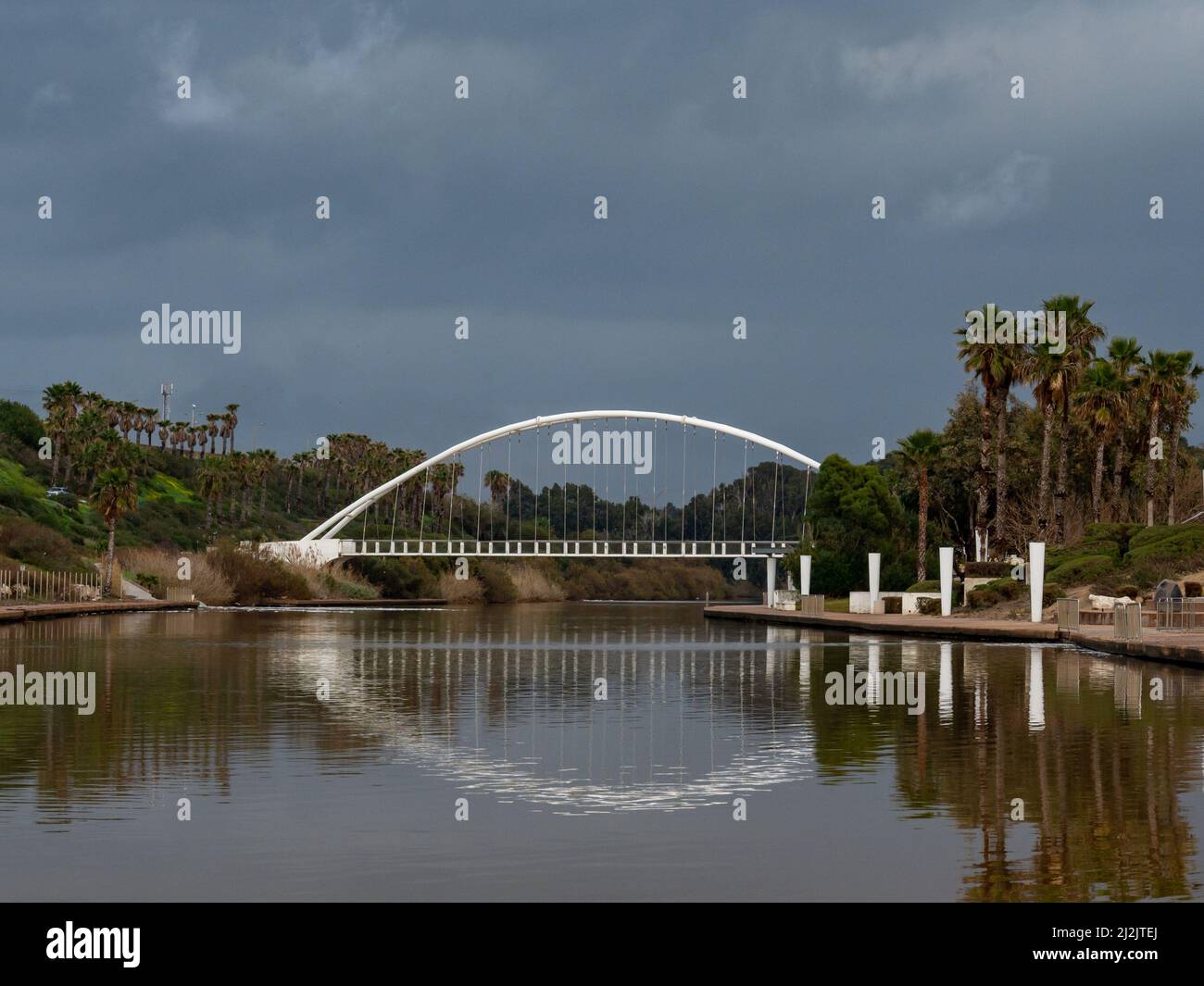 An arc bridge over the river in a recreation and amusement park. In the ...