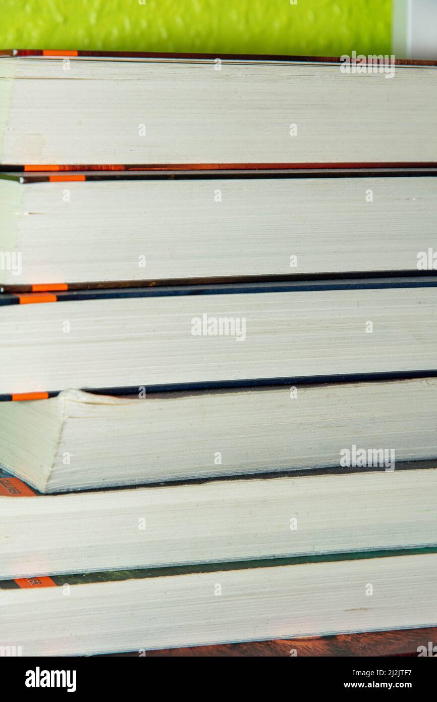 Stack of books white pages in front of green Stock Photo - Alamy