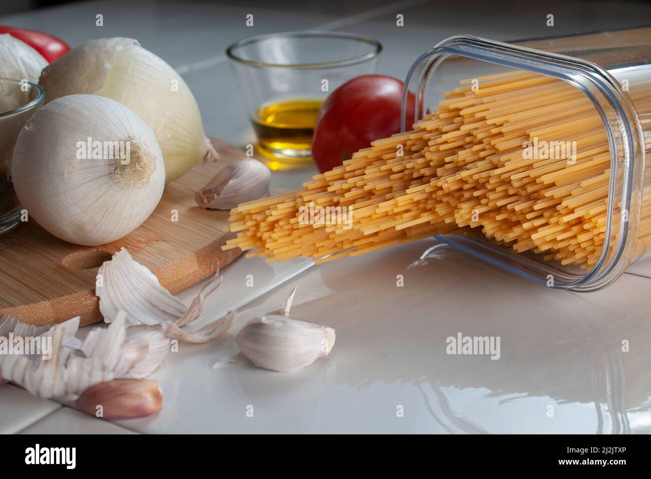 Macro photography, Raw, uncooked spaghetti with ingredients on a table ...