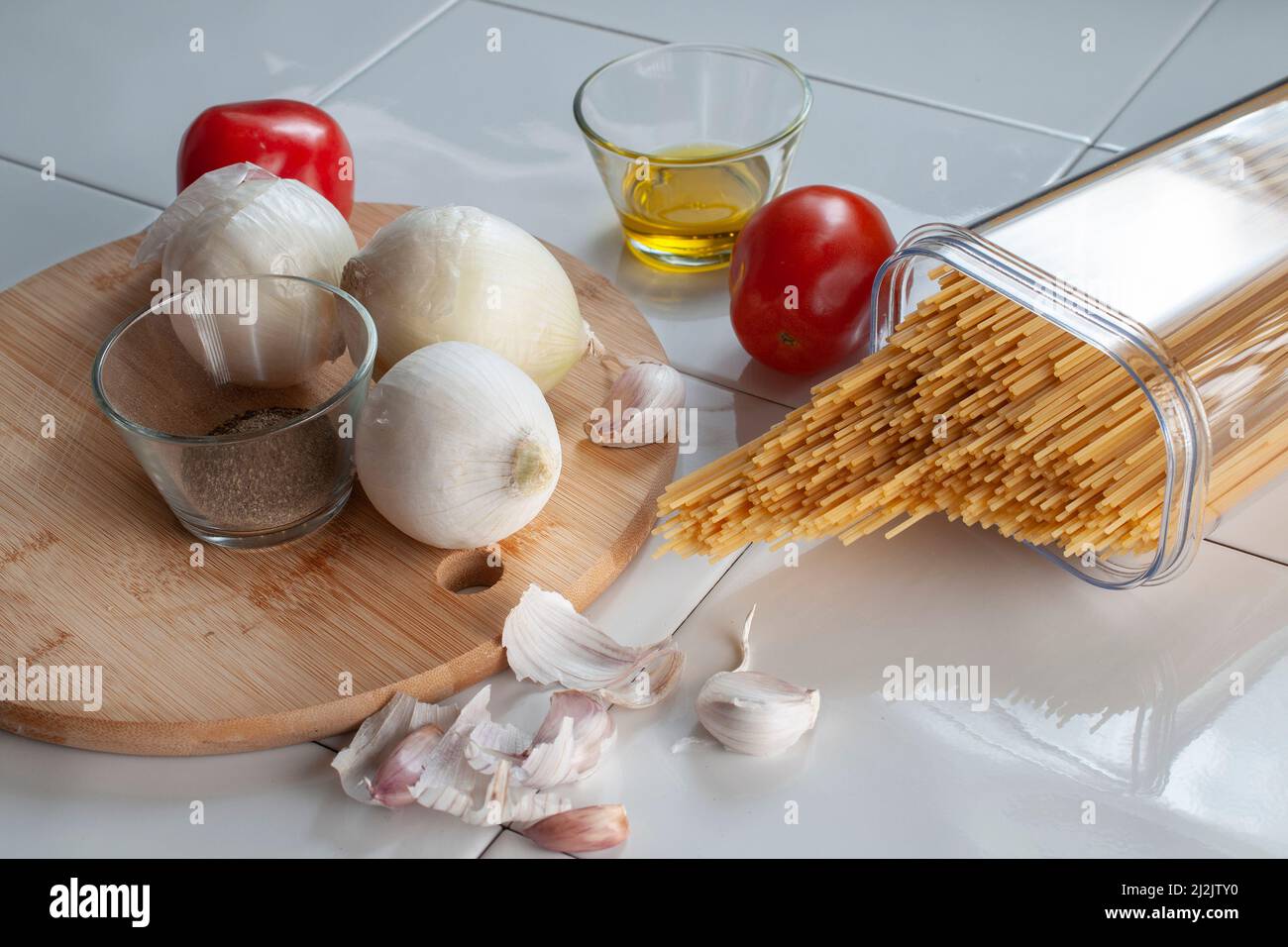 Macro photography, Raw, uncooked spaghetti with ingredients on a table ...
