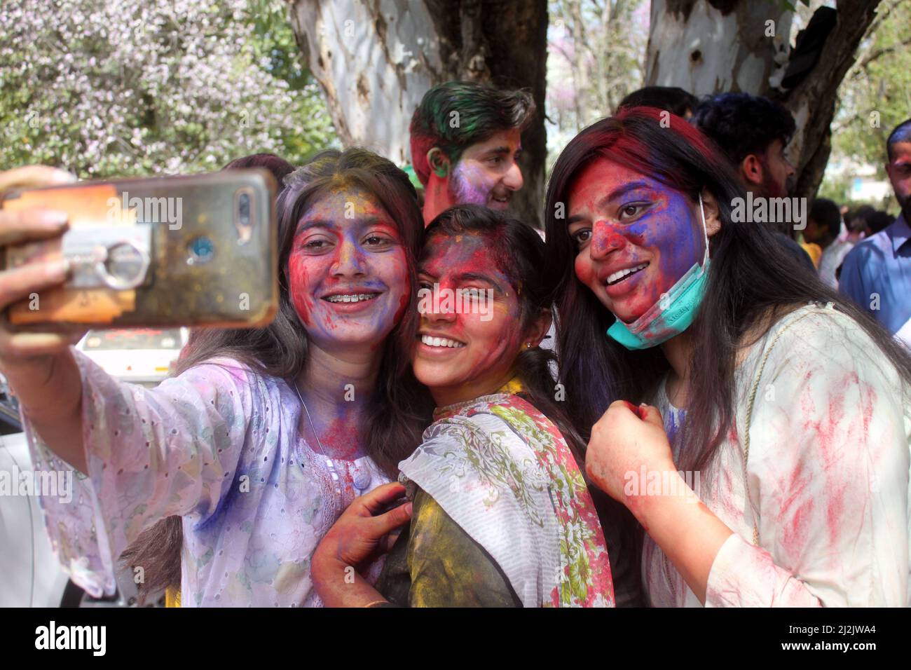Islamabad, Pakistan. 2nd Apr, 2022. Girls take selfies during a color ...