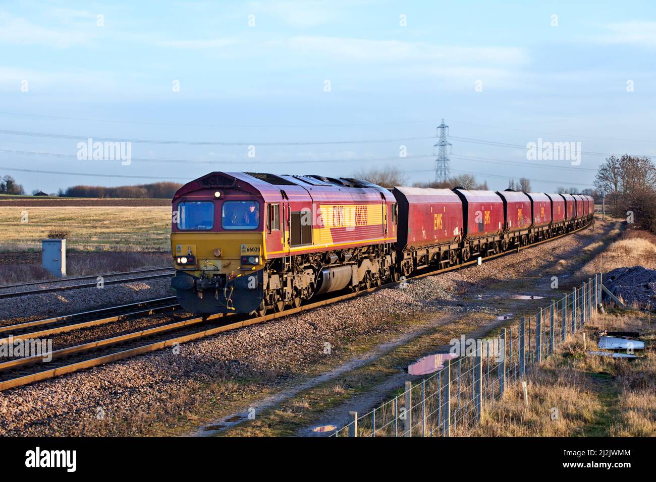 A DB cargo class 66 locomotive 66020 passing Burton Salmon with a freight train of loaded merry ...