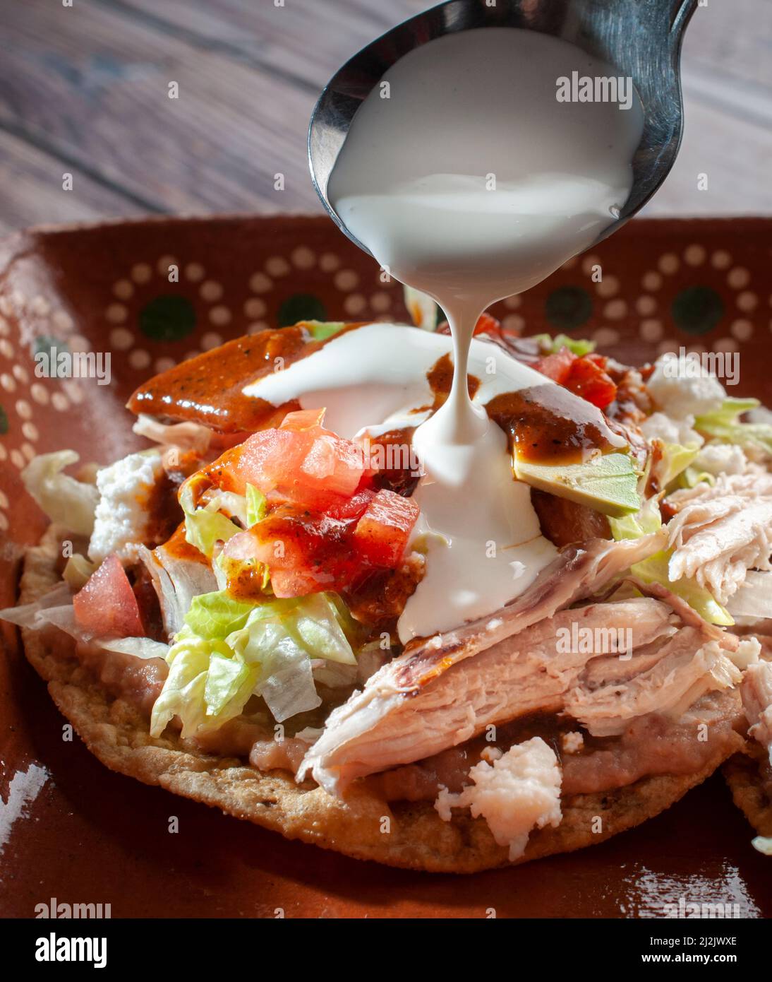 Traditional Mexican food tostadas on a clay or mud plate over a rusic ...