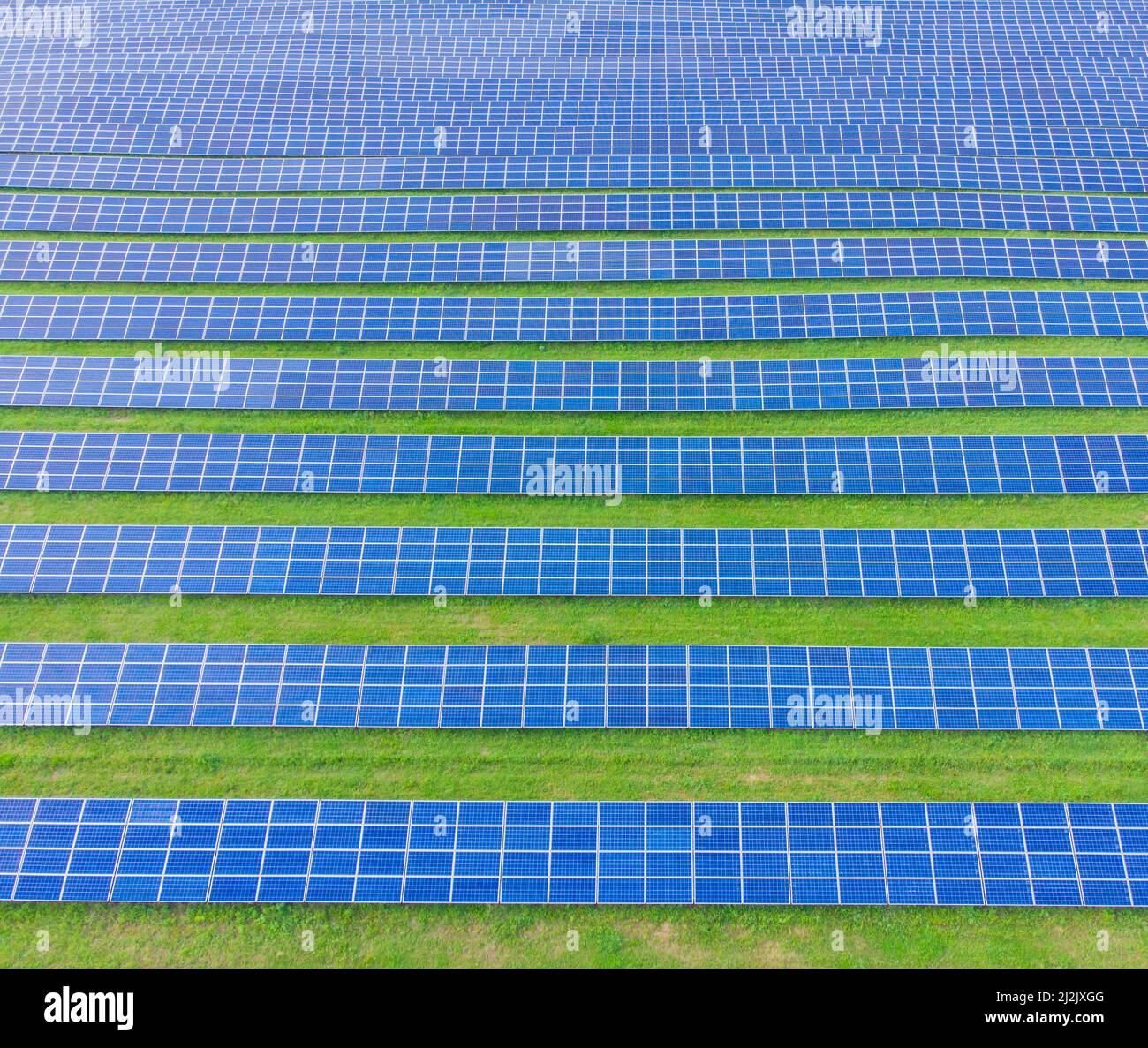 Drone aerial view of a photovoltaic solar system. Metallic blue solar ...