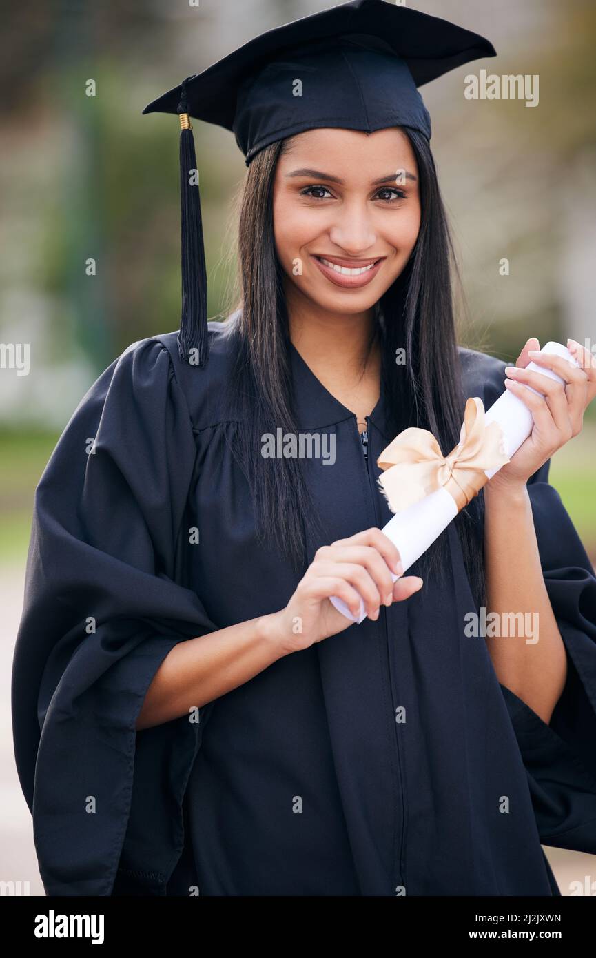 Shes destined for success. Portrait of a young woman holding her ...