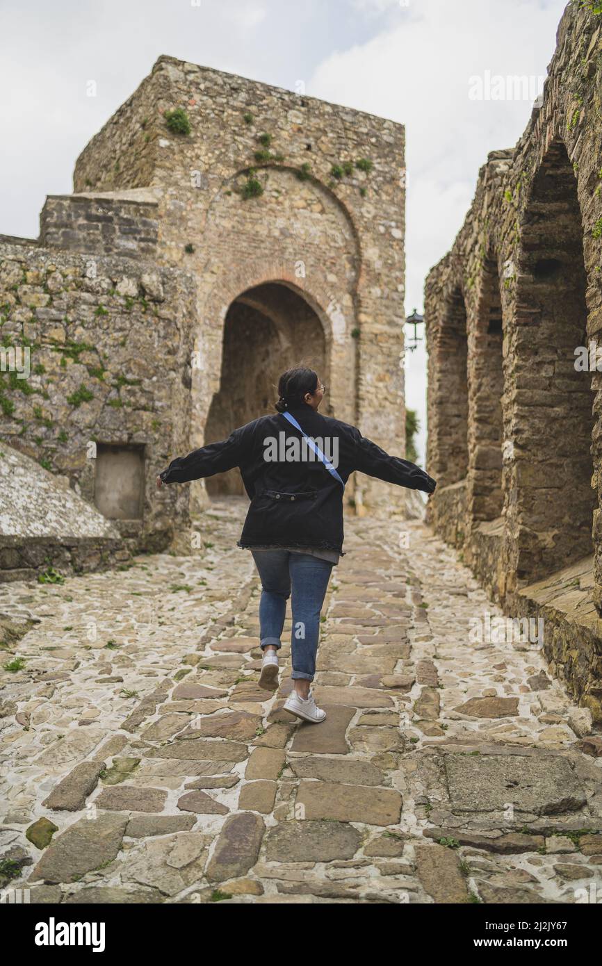 A view of a beautiful woman traveling in the streets of a small, cute ...