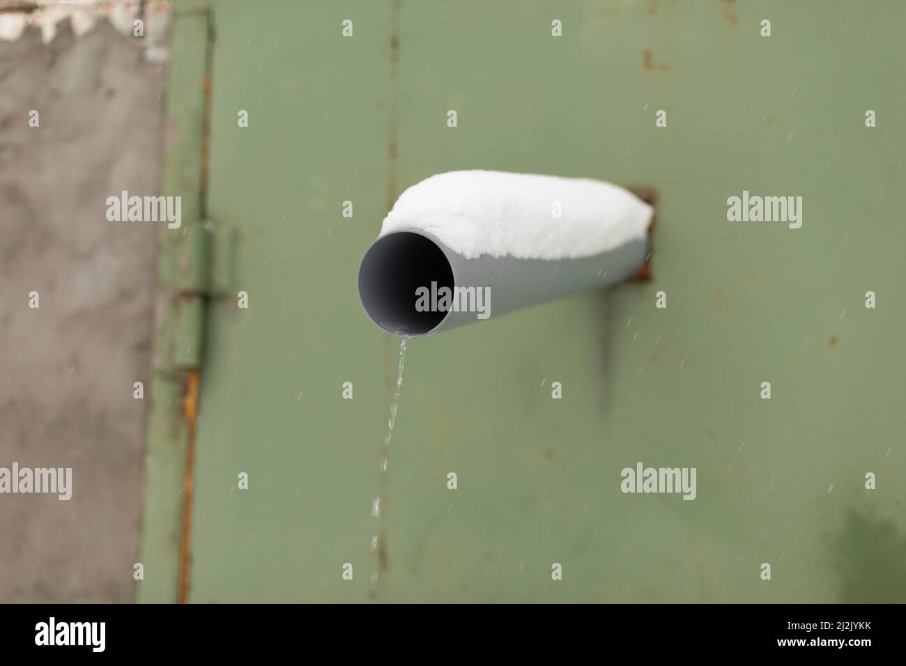 Pipe in wall. Draining water from sewer. Water conduit on street ...