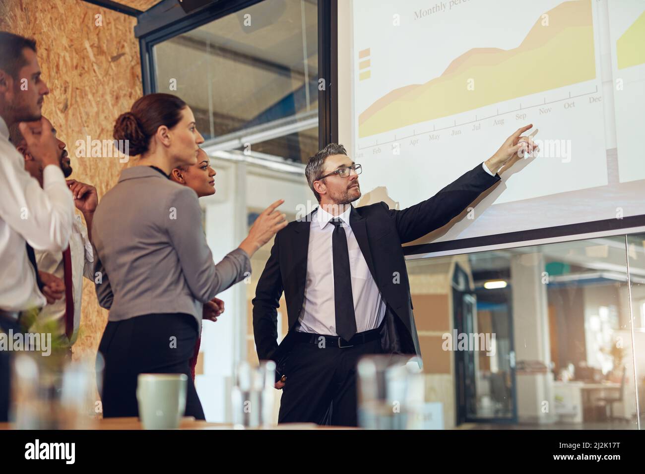 Running through the numbers with his team. Shot of an executive giving ...