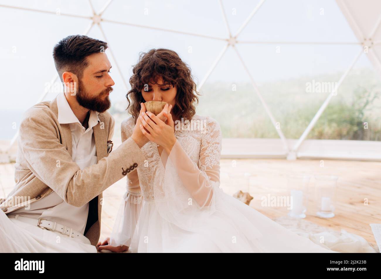 Tea ceremony at a boho wedding. Bride and groom in boho Stock Photo - Alamy