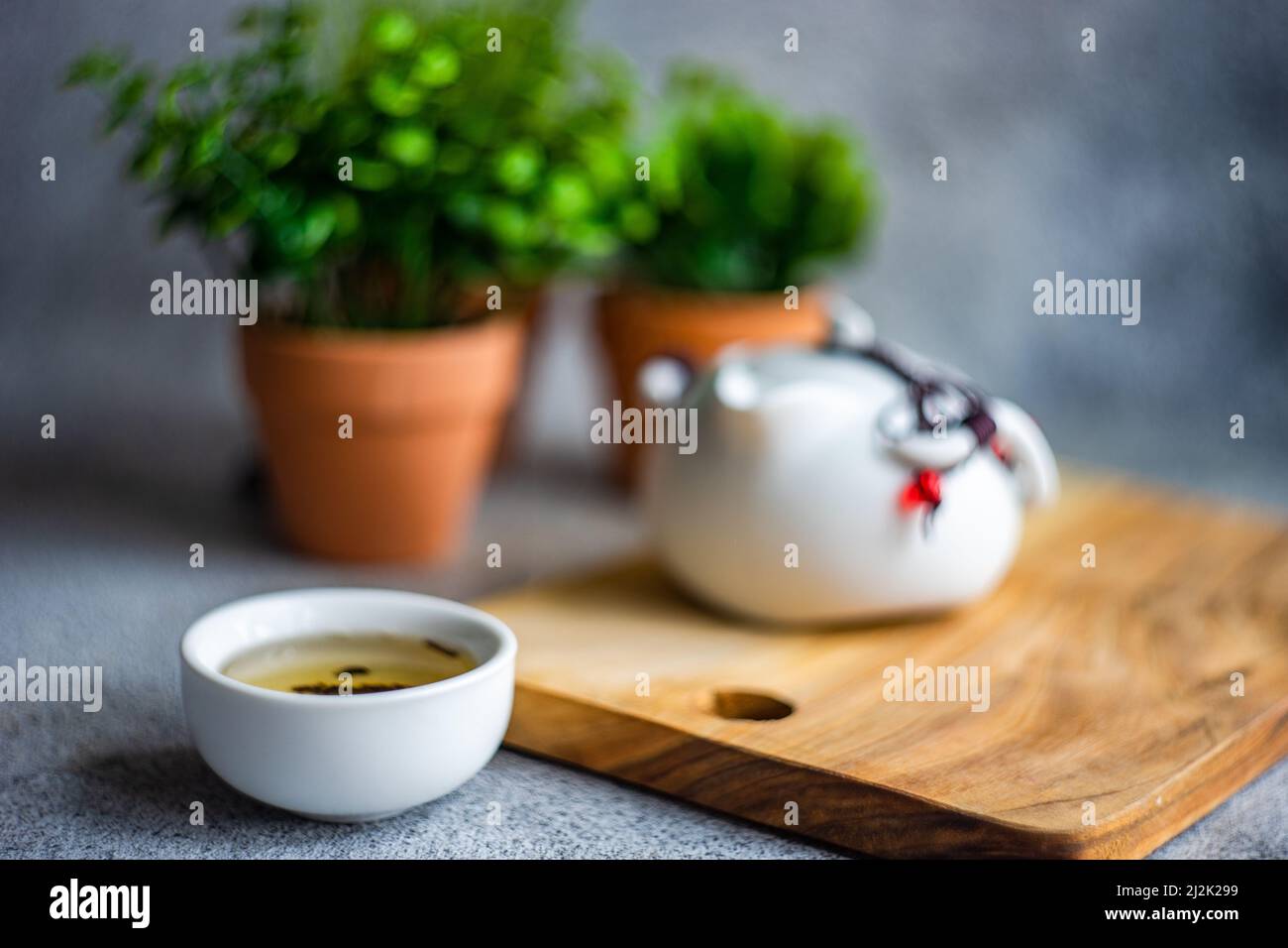 Close-up of an Asian tea set on a table with houseplants Stock Photo ... Close-up of an Asian tea set on a table with houseplants Stock Photo ...