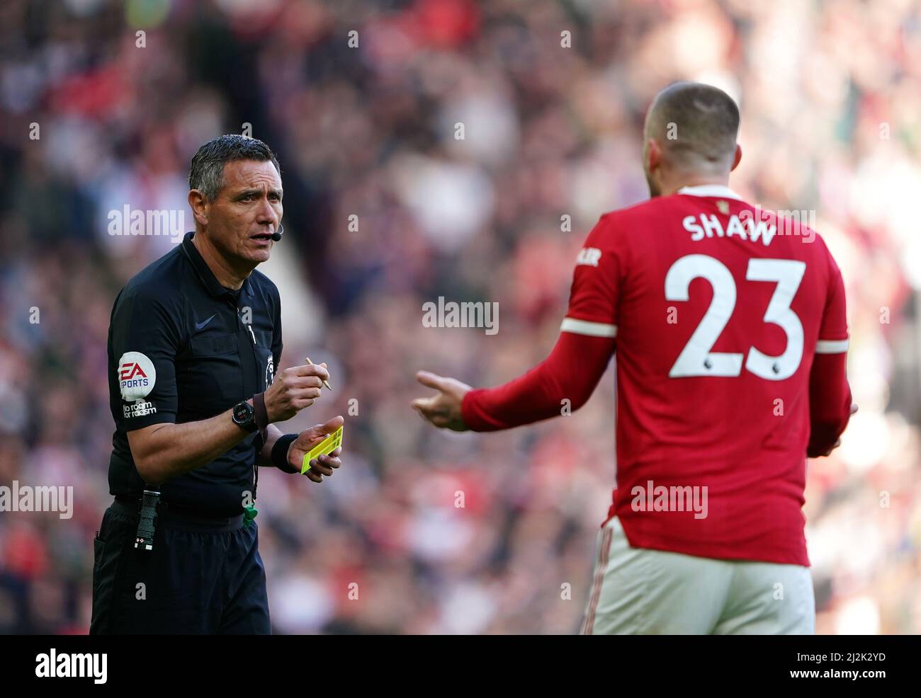 Referee Andre Marriner shows Manchester United's Luke Shaw a yellow ...