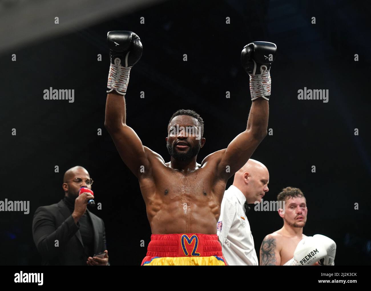Michael Likalu celebrates victory in the welter weight bout at at the ...