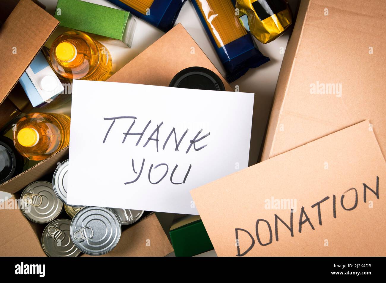 Food donations boxes with grocery products and cards with inscription ...
