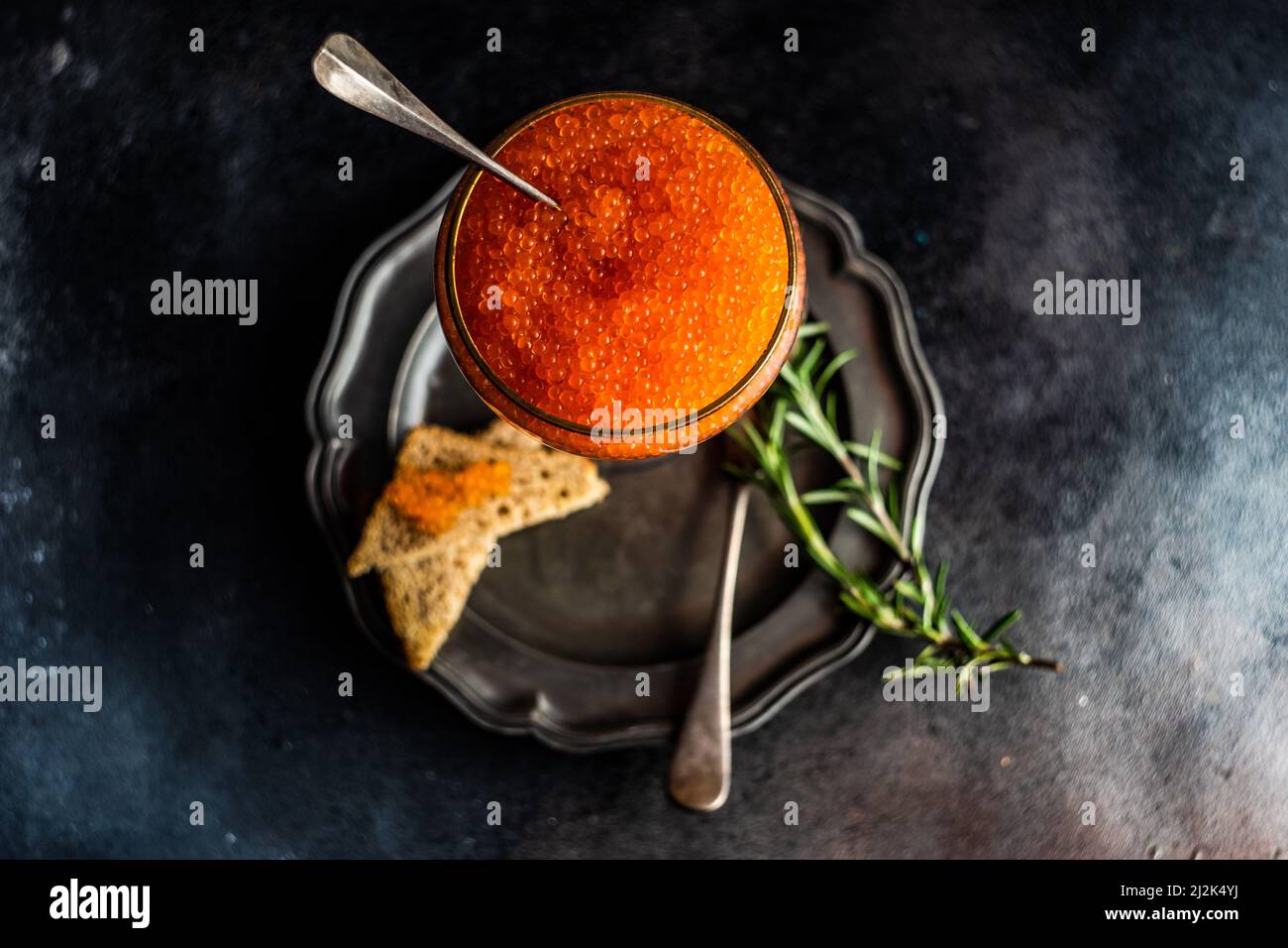 Overhead view of Red trout caviar with toast on a pewter plate Stock ...