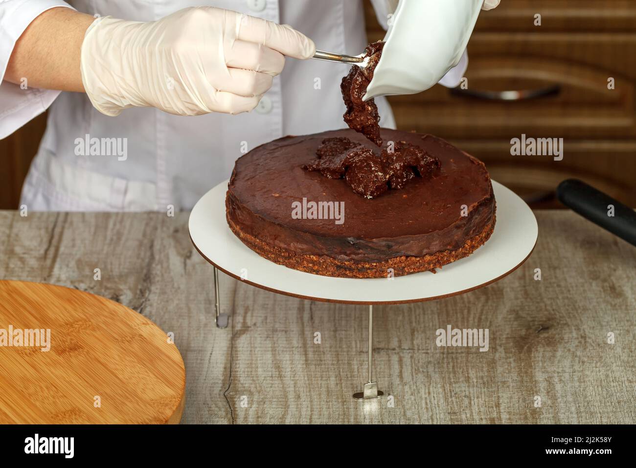 Preparing melted chocolate making cake hi-res stock photography and ...