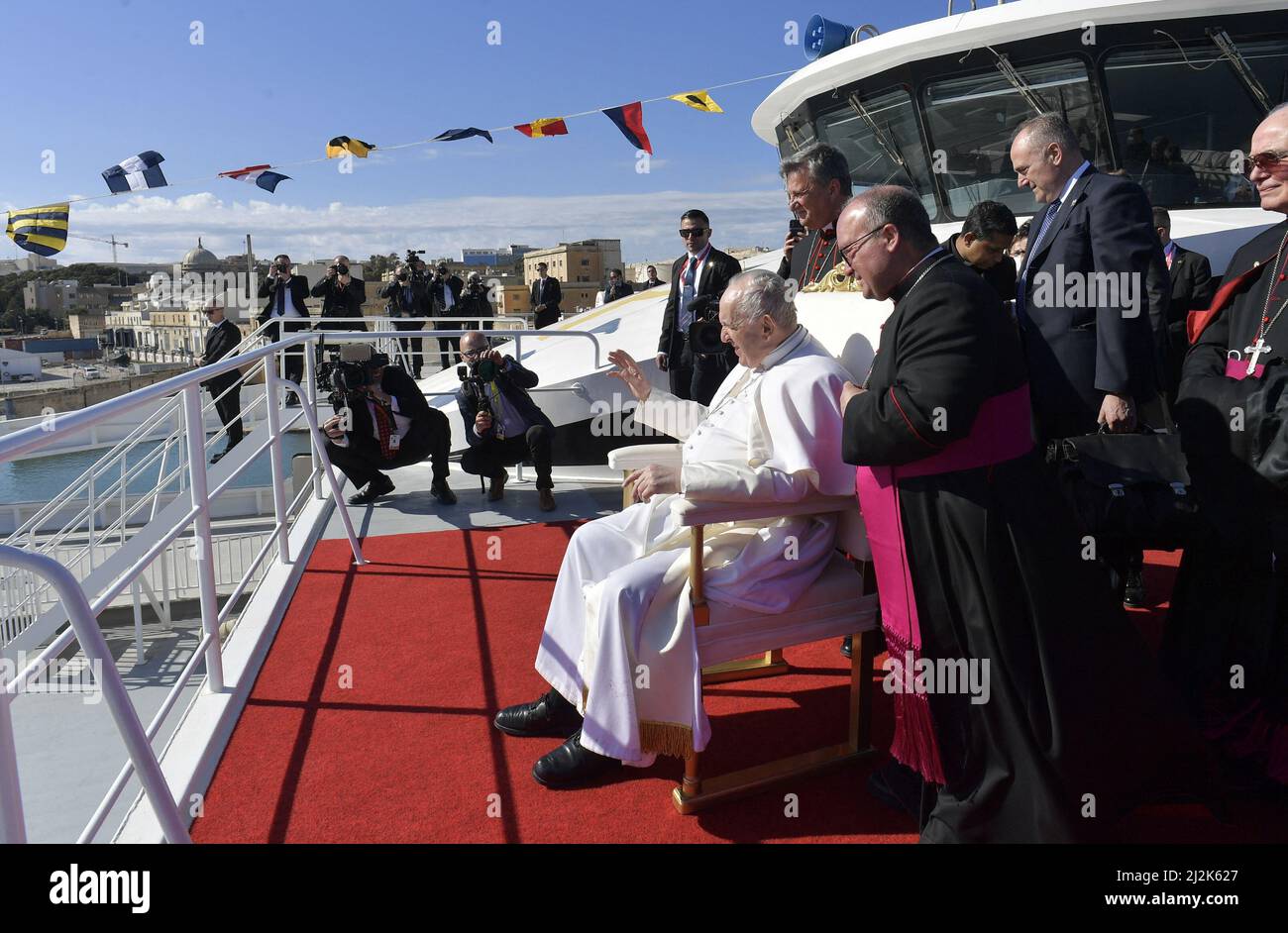 Pope Francis sits on a ferry-boat leaving Valletta's port on April 02 ...