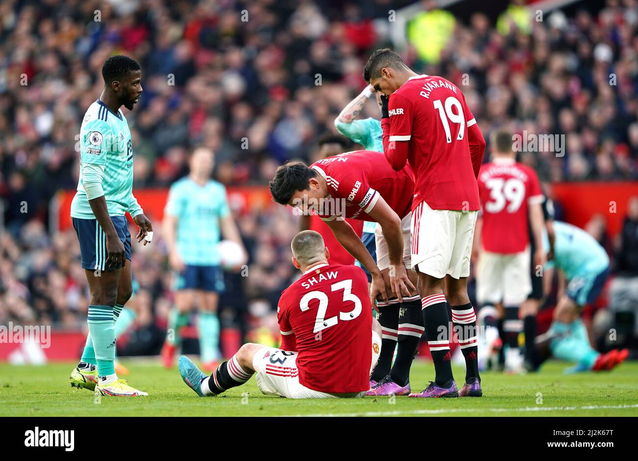 Manchester United's Luke Shaw (centre) reacts after picking up an ...