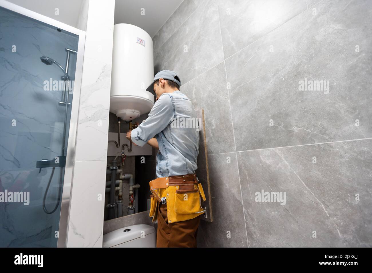 Young engineer adjusting autonomous heating Stock Photo - Alamy